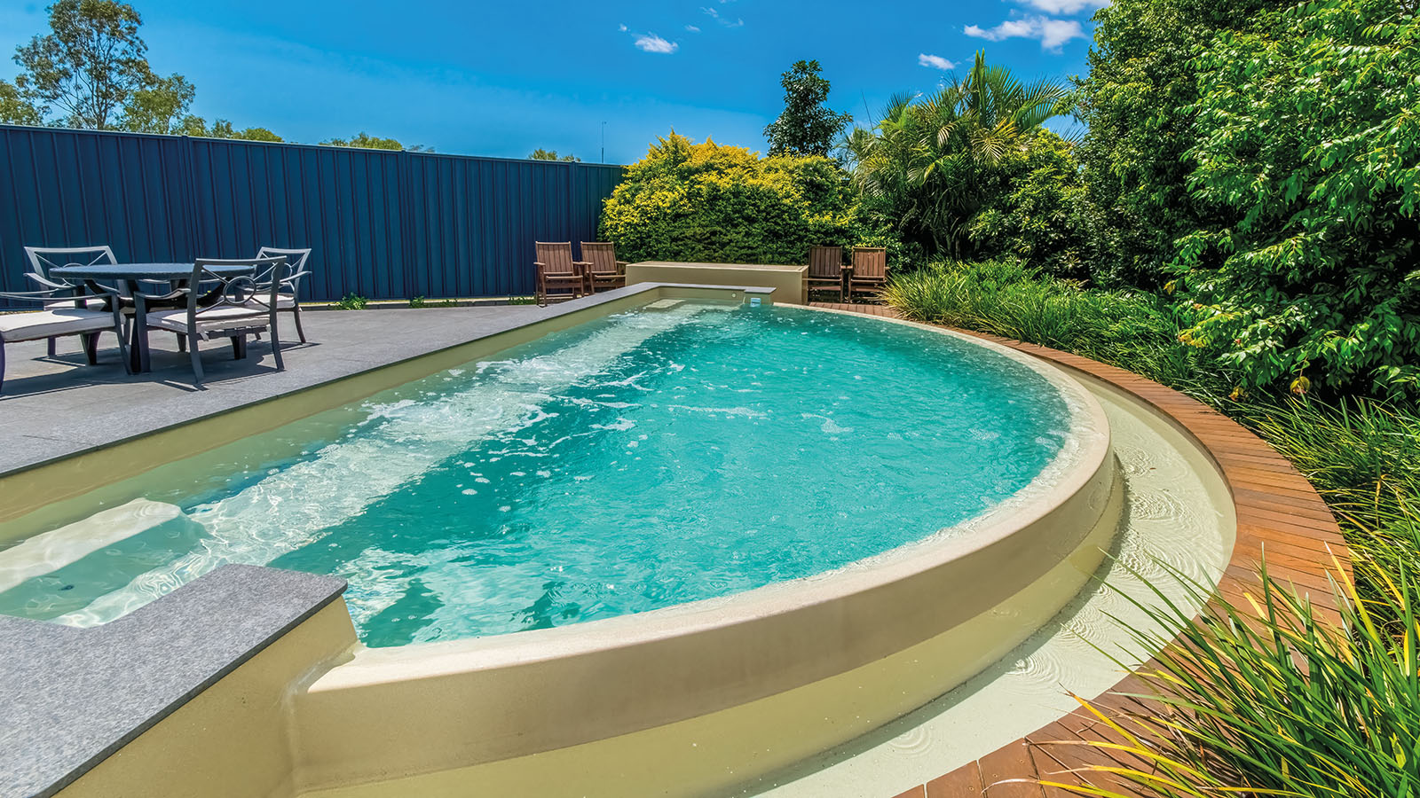The Glimmer - crescent fiberglass pool with spillover